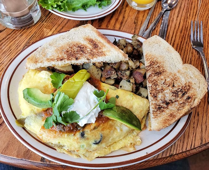 This isn't just an omelet&mdash;it's an edible postcard from flavor country, where avocado, sour cream, and perfectly folded eggs create breakfast harmony.