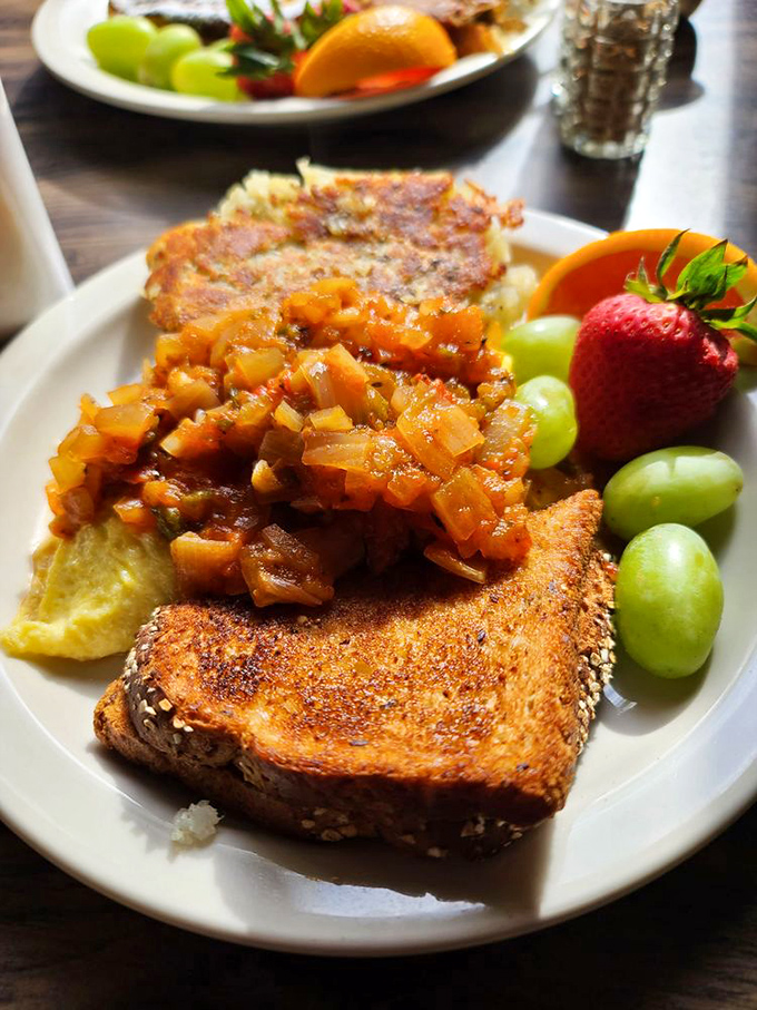 This isn't just breakfast&mdash;it's edible art. Caramelized onion compote crowns perfectly toasted bread alongside fresh fruit for a symphony of sweet and savory.