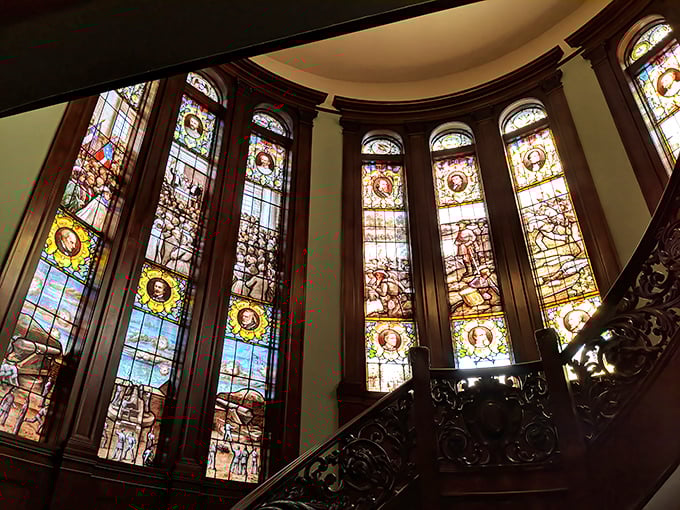The magnificent stained glass windows aren't depicting saints, but Civil War scenes. Sunlight streams through history, painting the staircase with kaleidoscopic colors.