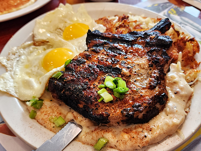 A pork chop that commands respect, flanked by sunny-side-up eggs standing at attention. Breakfast of champions, indeed.