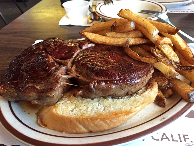Some sandwiches require a strategy meeting before the first bite. This oak-grilled masterpiece demands both hands, several napkins, and your complete attention.