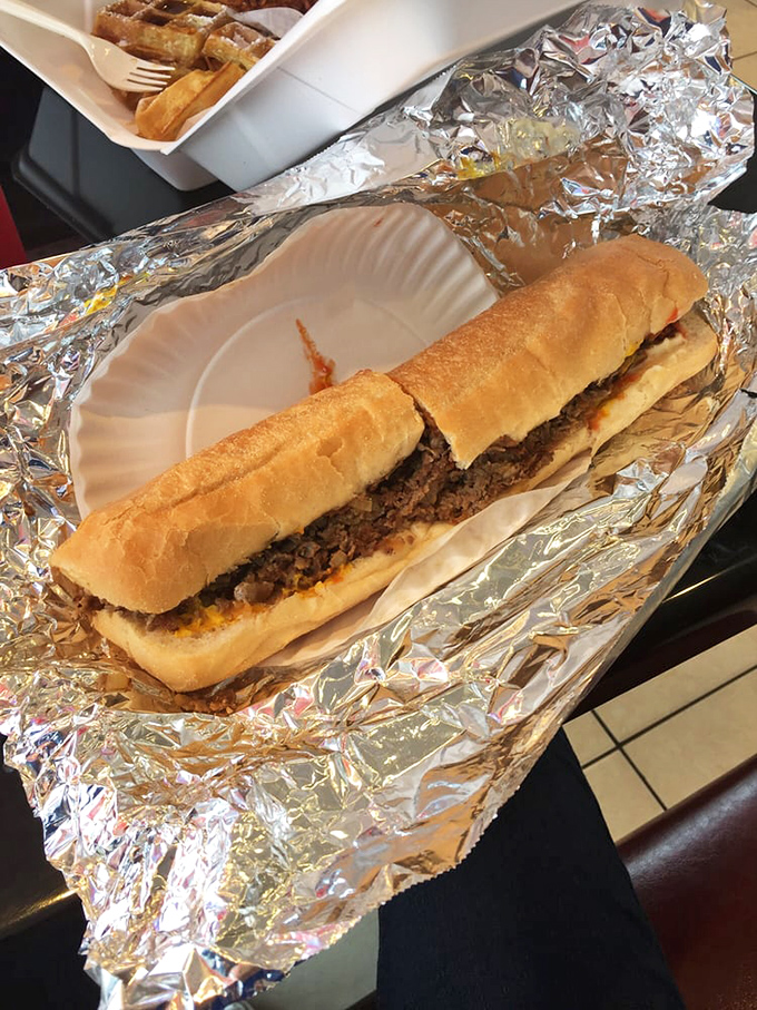 The steak and cheese sub lounges regally in its foil throne, a handheld feast that promises to silence hunger pangs with each savory bite.