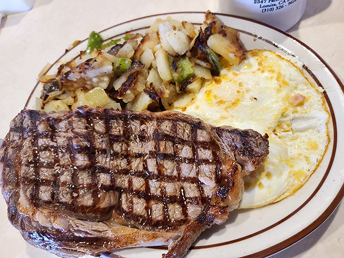 When a steak has grill marks this perfect, you know you're in good hands. Those eggs are sunshine on a plate.
