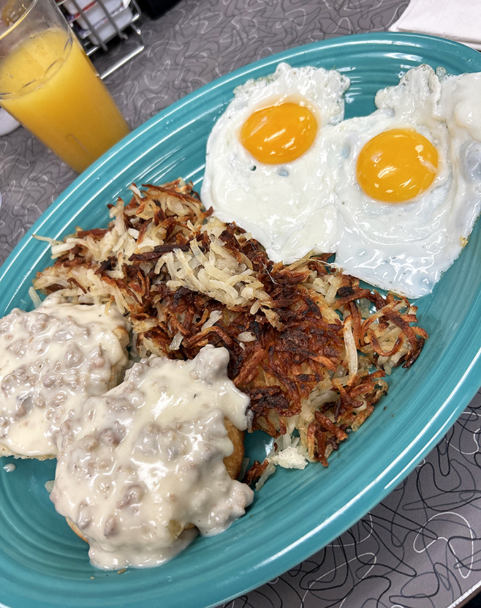 Breakfast of champions: perfectly sunny eggs, crispy hash browns, and creamy sausage gravy. The holy trinity of morning satisfaction.