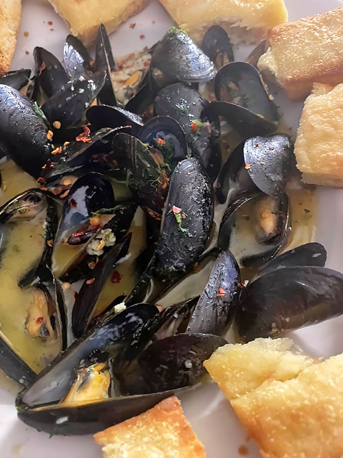 These steamed mussels arrive swimming in broth so good you'll want to drink it with a straw.