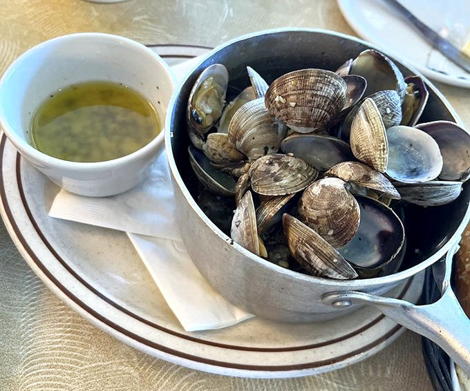 These steamed clams aren't just having a hot tub party &ndash; they're celebrating life with a buttery broth that demands bread for sopping duties.