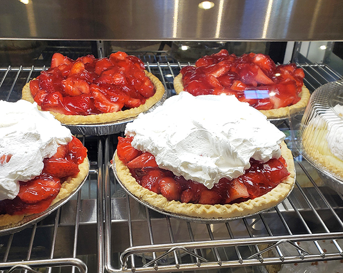 Fresh strawberry pies lined up like edible jewels waiting for their moment to shine.
