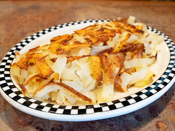 These hash browns achieve the culinary holy grail: crispy exterior, tender interior, and enough surface area to soak up egg yolk like nature intended.