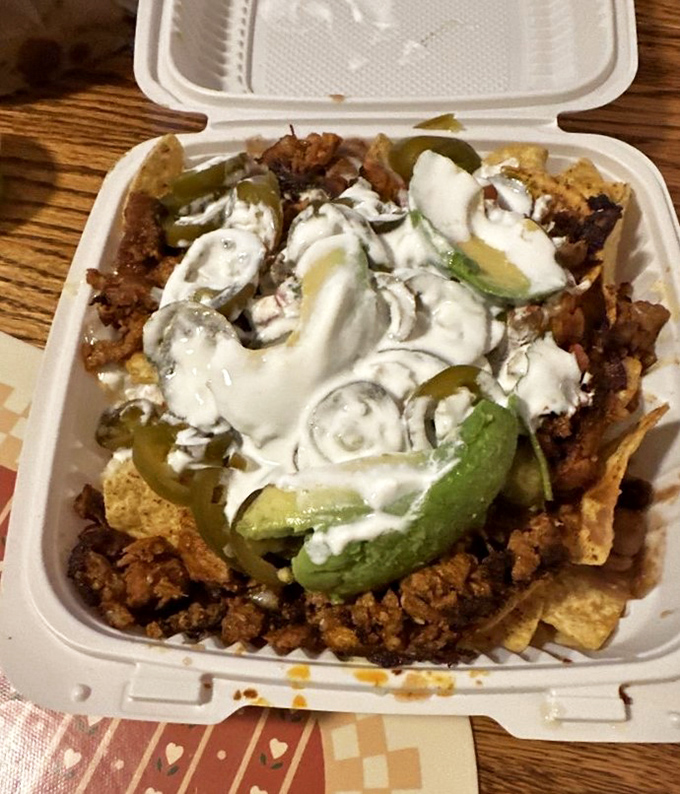 These nachos don't play games—they come fully loaded with al pastor, avocado, and enough sour cream to make your cardiologist wince.