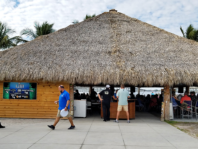 TT's Tiki Bar embodies the Florida retirement dream: sipping something cold under a thatched roof while watching other people's vacation photos turn green with envy.