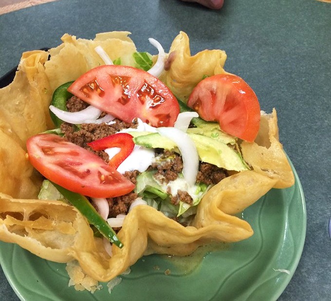 The taco salad's crispy shell cradles a fiesta of flavors. Fresh vegetables, seasoned meat, and creamy toppings create a textural adventure that puts sad desk salads to shame.
