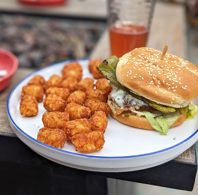 Golden-brown tater tots alongside a perfectly dressed burger&mdash;proof that sometimes the sidekick deserves equal billing with the hero.