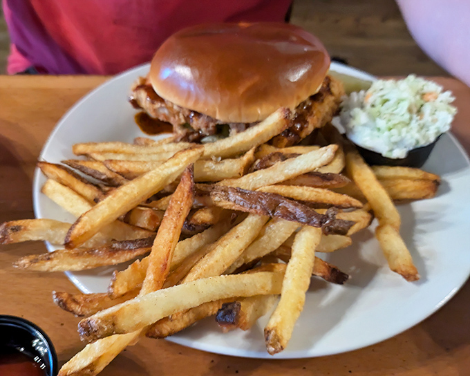 This isn't just a burger—it's architectural perfection. Golden fries, a toasted bun, and a side of slaw that doesn't know it's supposed to be an afterthought.