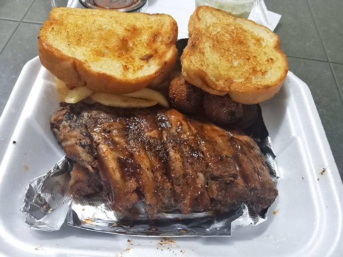 Ribs wrapped in foil like the precious gift they are. That Texas toast isn't just bread&mdash;it's an edible napkin waiting for its moment.