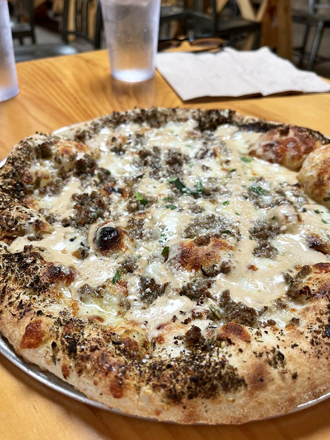 A white pizza that makes you question your lifelong allegiance to red sauce. The cheese blend creates that stretchy, Instagram-worthy pull that food dreams are made of.