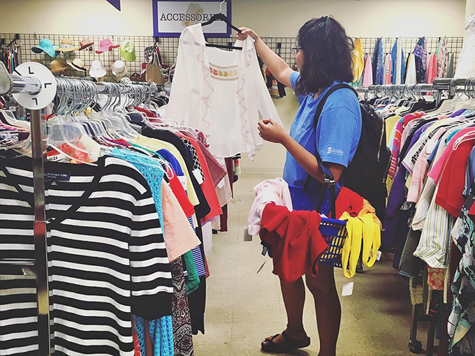 The thrill of the hunt captured in action &ndash; each garment inspection is like archaeological fieldwork for fashion treasures.