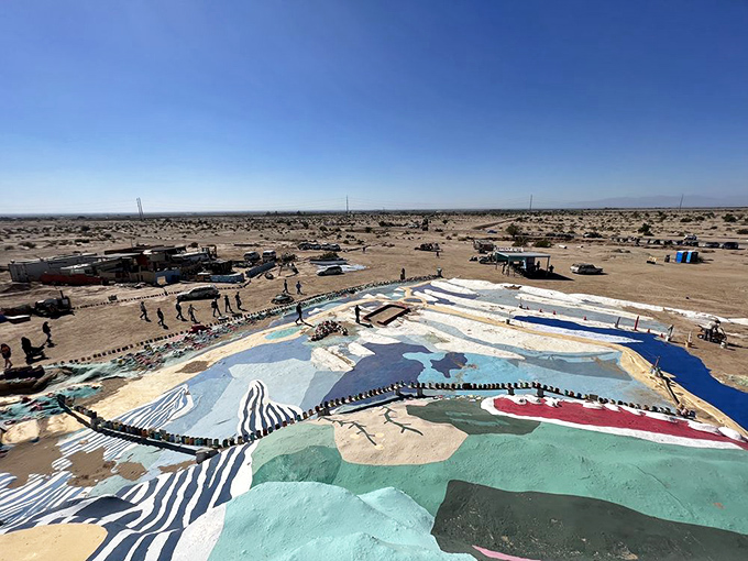 From above, Salvation Mountain reveals itself as an intricate patchwork of color against the stark desert floor, like an artist's palette spilled across the sand.