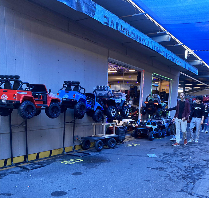 Miniature monster trucks and toy cars that promise big adventures for little hands. Childhood dreams parked in neat rows, waiting for imagination.