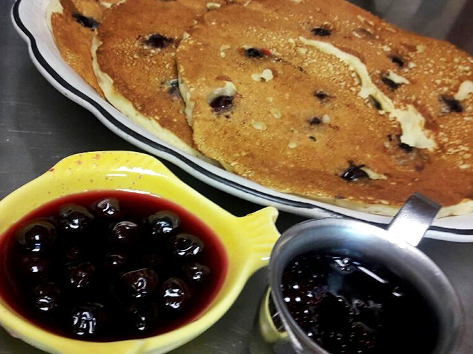 These blueberry pancakes aren't just blue-dotted—they're practically a blueberry convention with their own syrup delegation.
