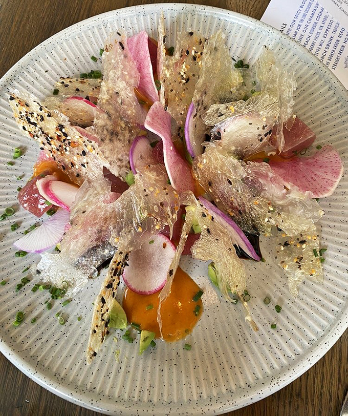 Tuna crudo that's dressed better than most people at the opera. Those translucent crackers add texture that makes each bite a tiny celebration.
