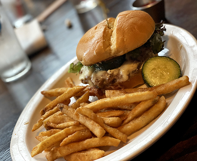 A burger that's dressed better than most people at a wedding. Those fries are clearly its loyal entourage.