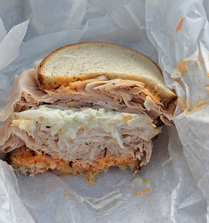 Turkey stacked higher than a Thanksgiving family argument. The slaw adds crunch while that spread whispers, "You're going to need a nap after this."