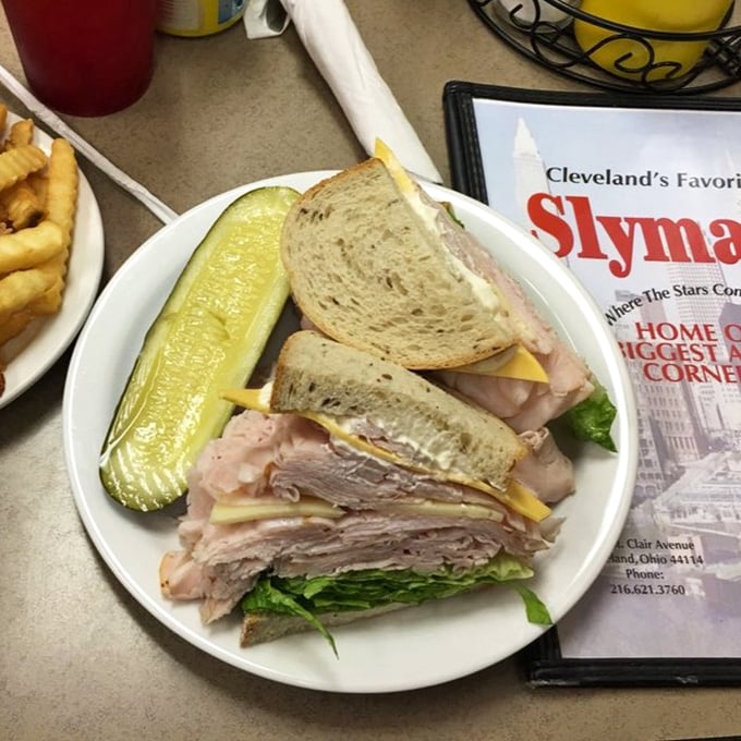 The turkey club stands tall and proud, like a delicious skyscraper of comfort. Three stories of satisfaction with lettuce as the zoning requirement.