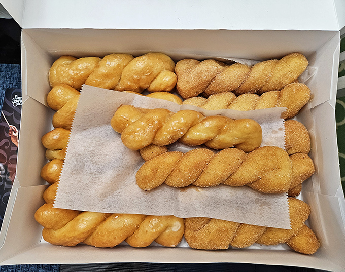 Twisted donuts lined up like delicious soldiers, half glazed and half cinnamon-sugared, ready to report for breakfast duty in your eager hands.