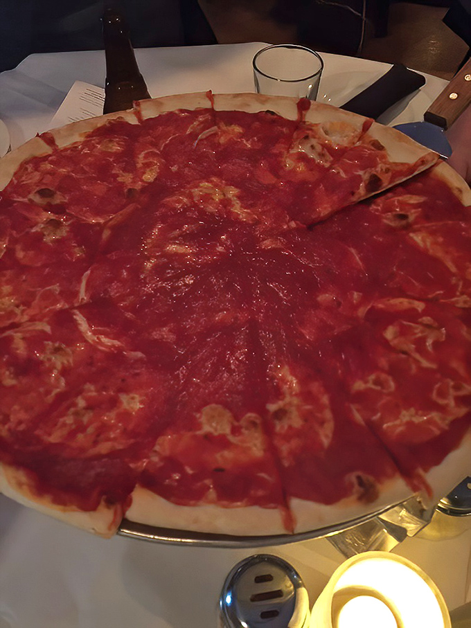 The famous Upside Down Pizza flips convention on its head—sauce proudly riding atop the cheese like a culinary revolutionary.