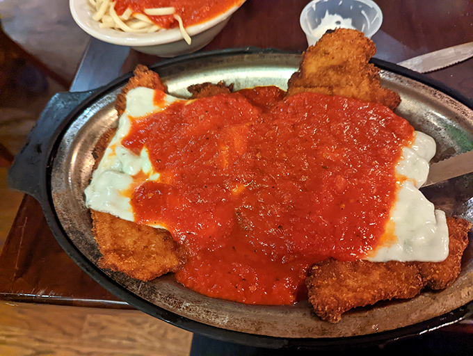 Veal parmigiana so generous, you'll need a sherpa to help you navigate from edge to edge.