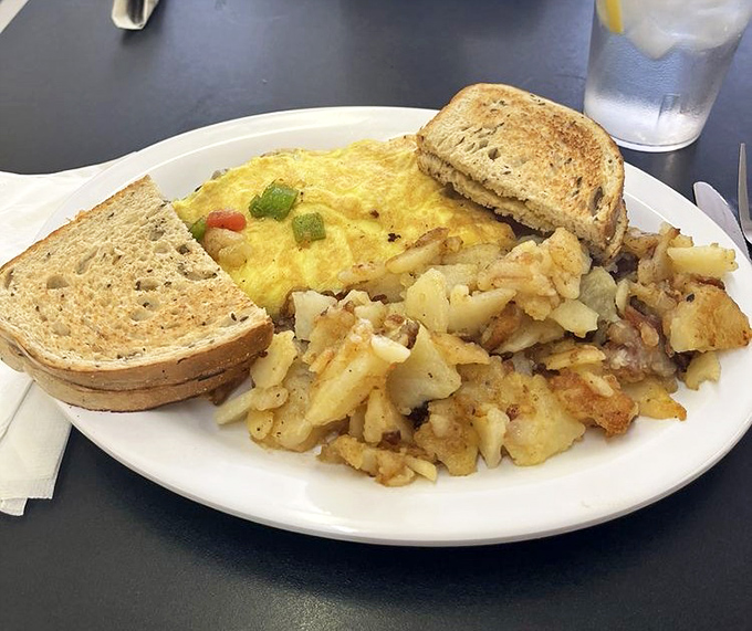 A proper diner breakfast: fluffy eggs nestled alongside golden home fries and hearty toast&mdash;simple perfection that fancy brunch spots try desperately to replicate.