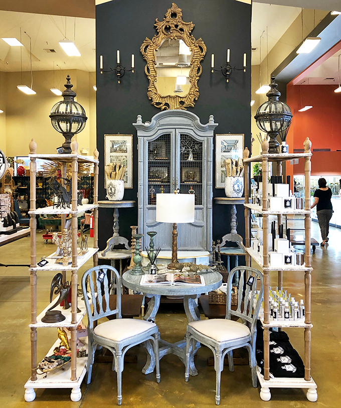 French Provincial meets Hollywood Regency in this elegant vignette. That ornate mirror has reflected a thousand faces before yours—each equally mesmerized by its gilded frame.