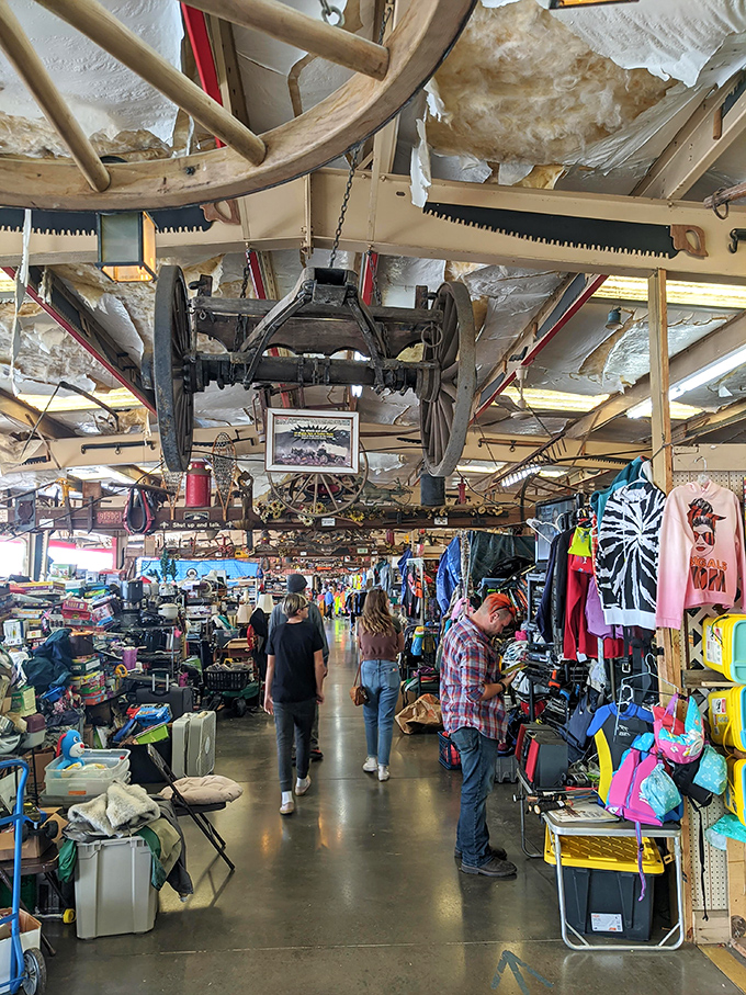 Look up! Vintage transportation meets modern merchandising as wagon wheels and antique farm equipment create an immersive shopping experience beneath the rafters.