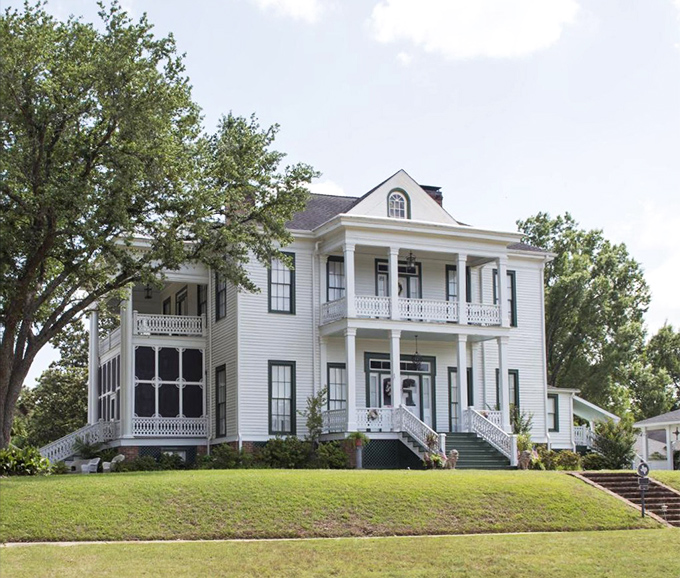 The W.P. Schluter House stands as a pristine example of Southern architecture that makes you wonder if Scarlett O'Hara might appear on that porch at any moment.