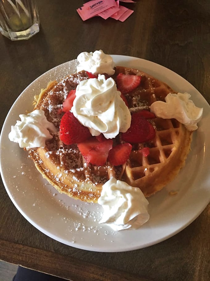 This Belgian waffle isn't just breakfast, it's architecture&mdash;a perfect grid of crispy exterior holding strawberries and whipped cream like edible jewelry.