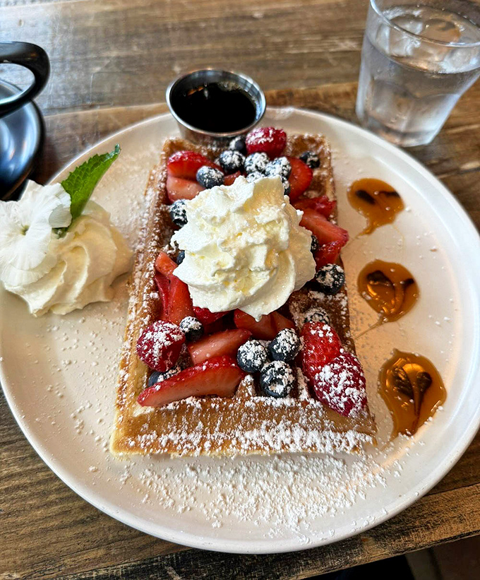 This berry-topped waffle with whipped cream is what breakfast looks like in your sweetest dreams &ndash; complete with maple syrup puddles.