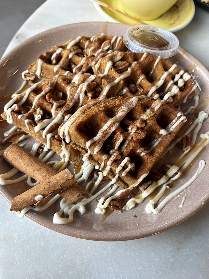 These cinnamon-dusted waffles with their artful drizzle of sweetness are what breakfast dreams are made of &ndash; no snooze button needed.