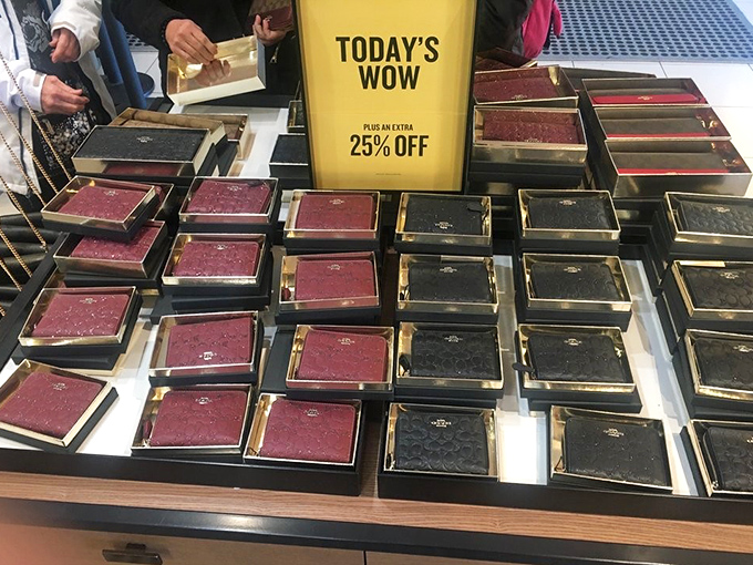 "Today's WOW" indeed &ndash; Coach wallets lined up like soldiers, their burgundy and black leather gleaming under strategic lighting.