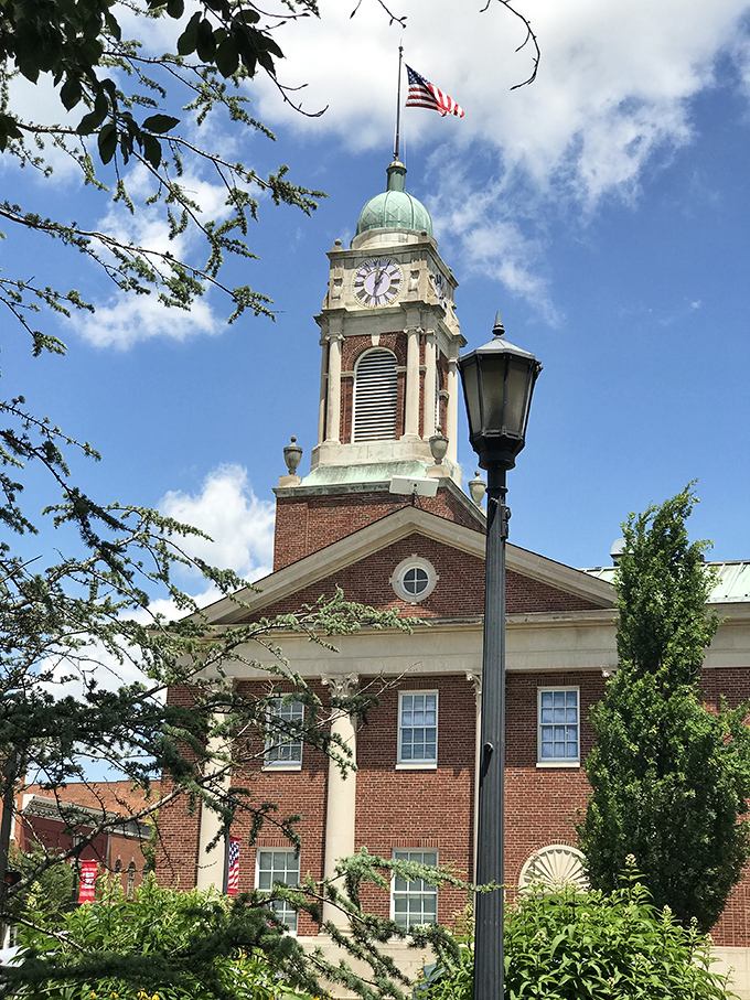 The Warren County Courthouse rises proudly with its distinctive clock tower and American flag, a brick-and-mortar testament to small-town governance.