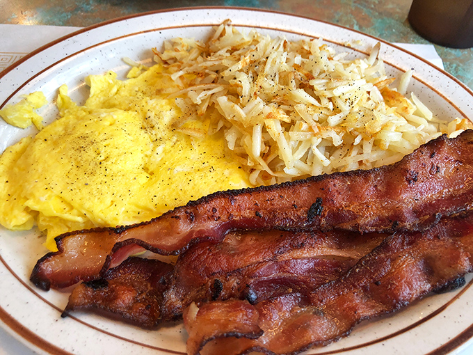 This isn't just breakfast&mdash;it's morning therapy. Golden omelet filled with western goodness beside bacon cooked to that perfect crisp-yet-chewy sweet spot.