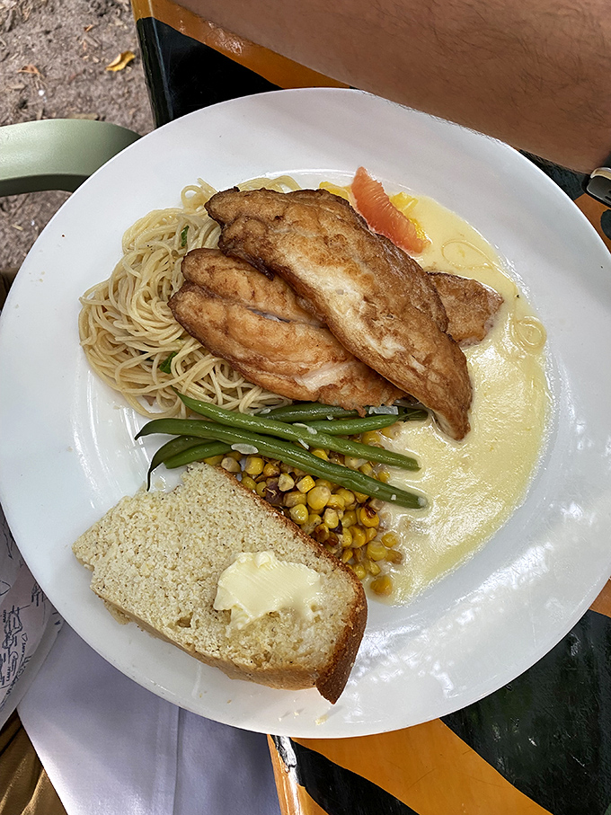Fresh yellowtail snapper served with angel hair pasta and vegetables – because sometimes Florida's coastal treasures deserve the full fine-dining treatment.