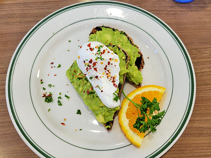 Avocado toast: California's gift to breakfast that's worth every penny. This version's poached egg and red pepper flakes elevate it beyond basic status.