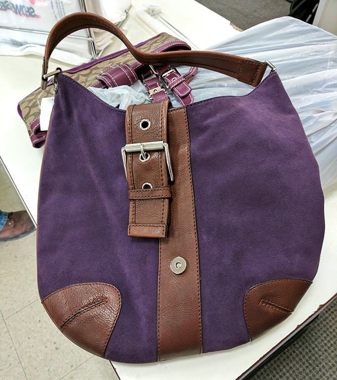 This purple suede and leather handbag isn't just pre-loved—it's ready for its second act in someone's fashion story.