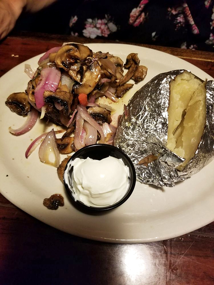 The legendary baked potato, wrapped in foil like the culinary gift it is. Those saut&eacute;ed mushrooms and onions are its perfect dance partners.