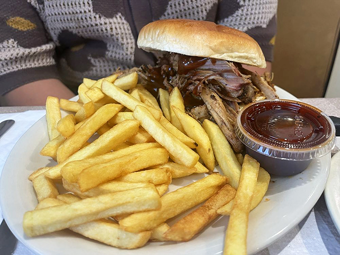 A BBQ sandwich that doesn't need fancy presentation to impress. Those fries aren't just sides—they're supporting actors deserving of their own award.