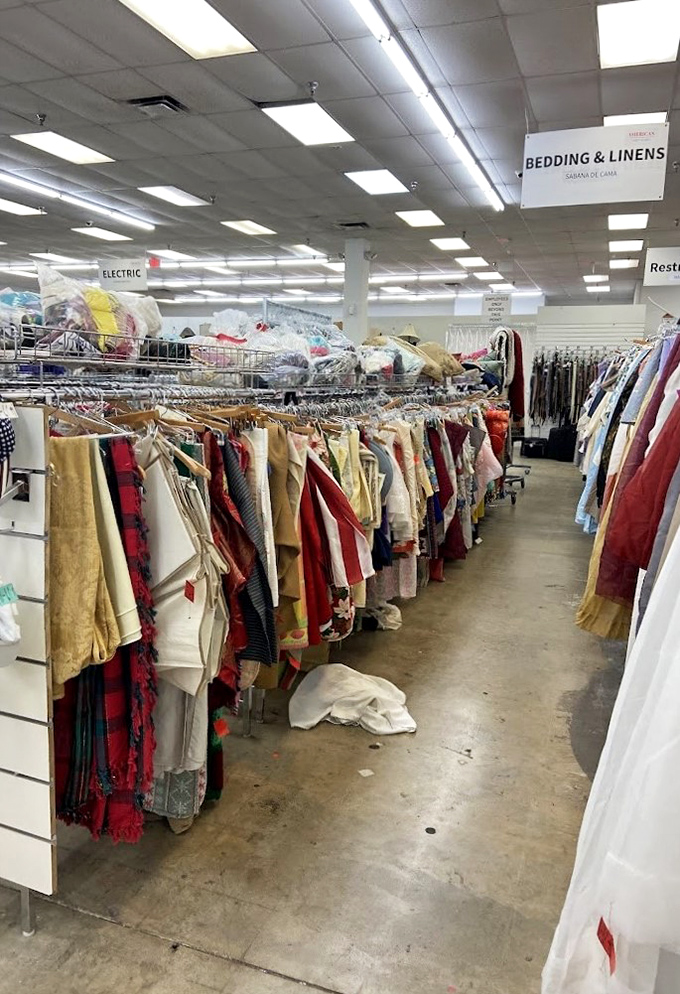 The "Bedding & Linens" sign points the way to domestic treasures. Someone's abandoned curtains might be exactly what your living room needs.
