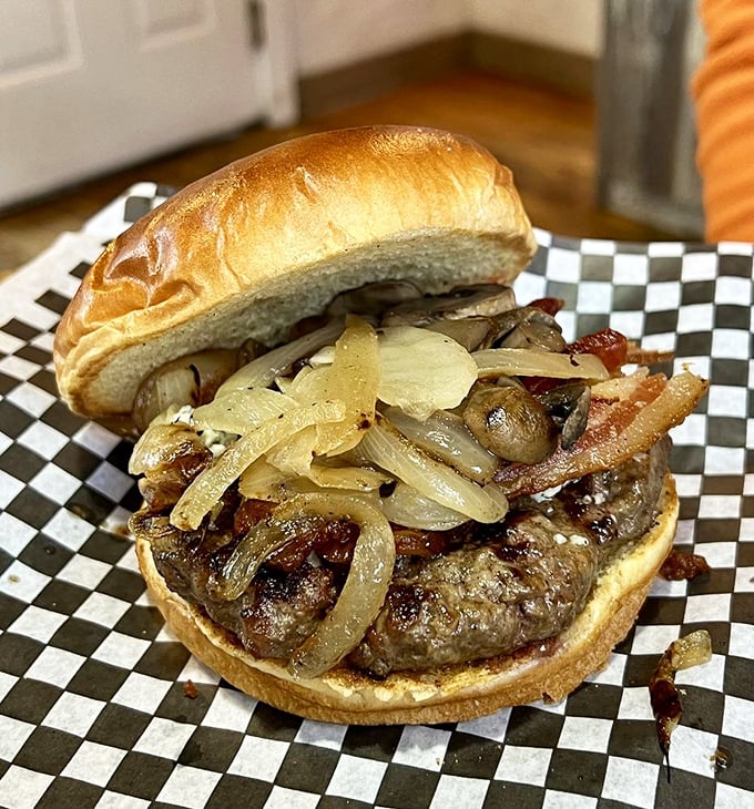 This burger isn't just topped with caramelized onions&mdash;it's crowned with them, creating a savory-sweet harmony that makes you forget you're eating in a checkered paper basket.