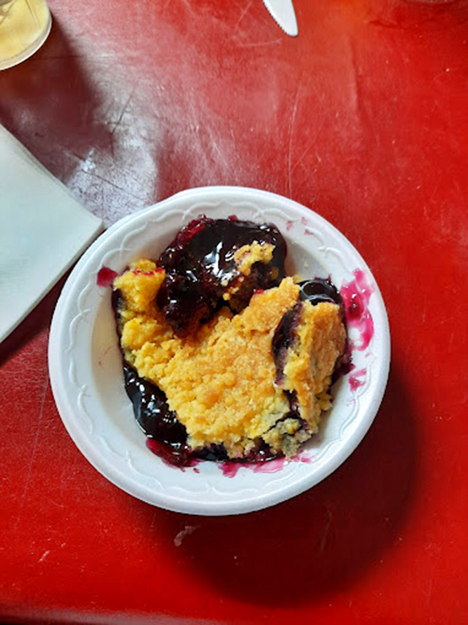 Blueberry cobbler that strikes the perfect balance between fruit and buttery crust. The purple-stained plate tells the delicious truth.
