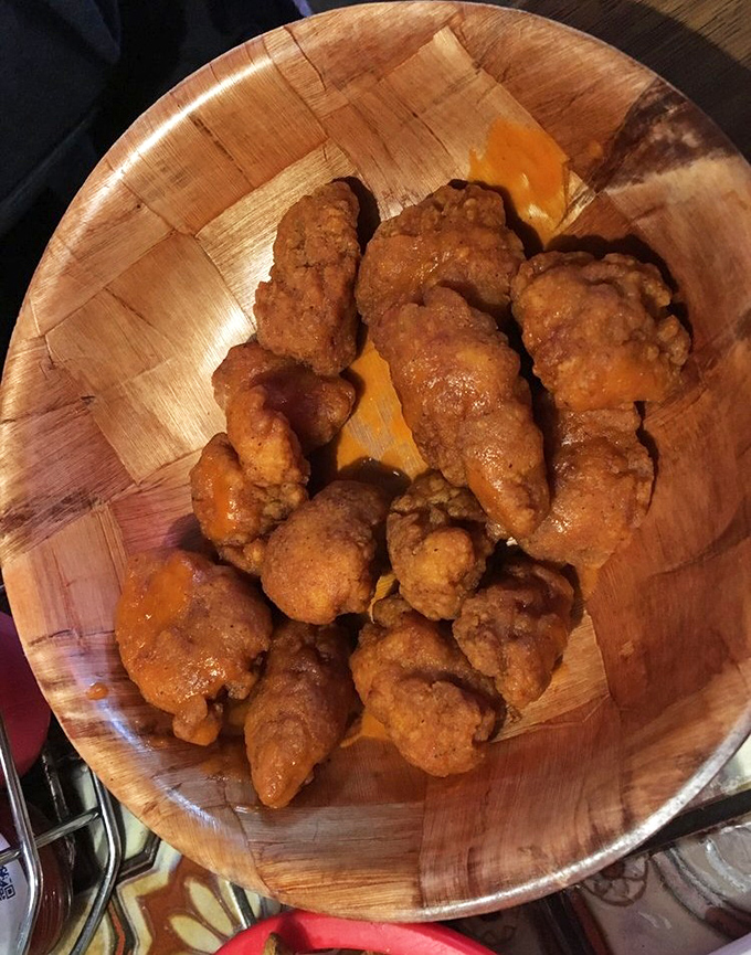 Buffalo wings that arrive looking like they've been kissed by fire and blessed with flavor.