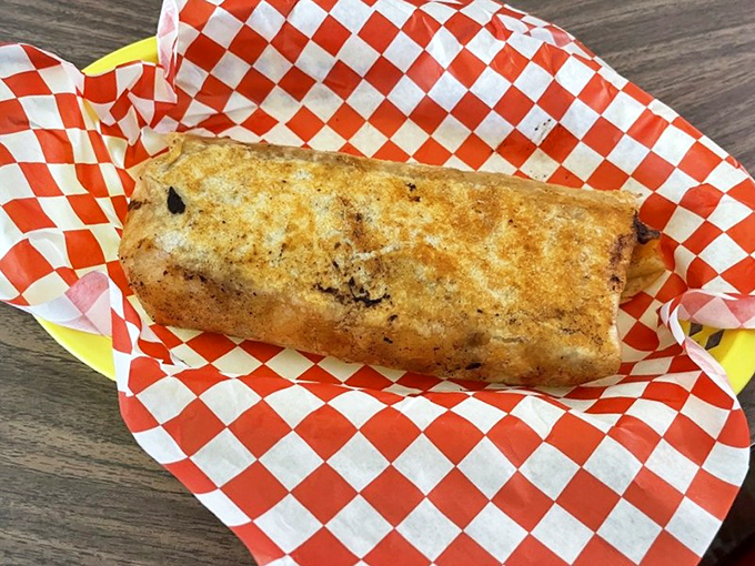 What appears to be a breakfast burrito wrapped in checkered paper&mdash;simple, substantial, and exactly what you'd want after a night of questionable decisions.